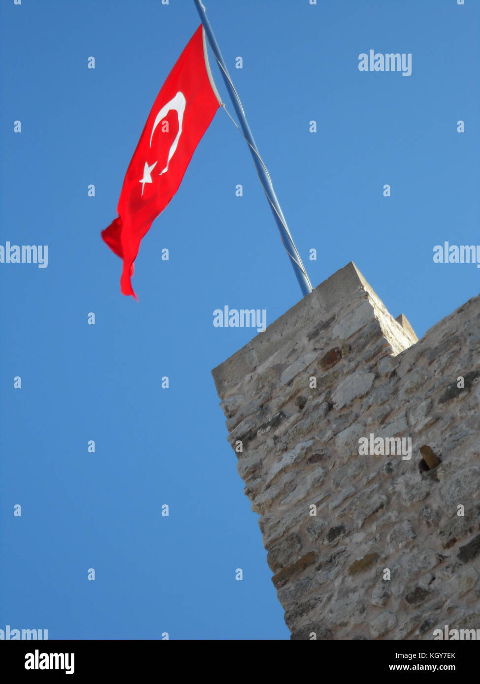 The Turkish national flag flying above the stone ramparts of Marmaris ...