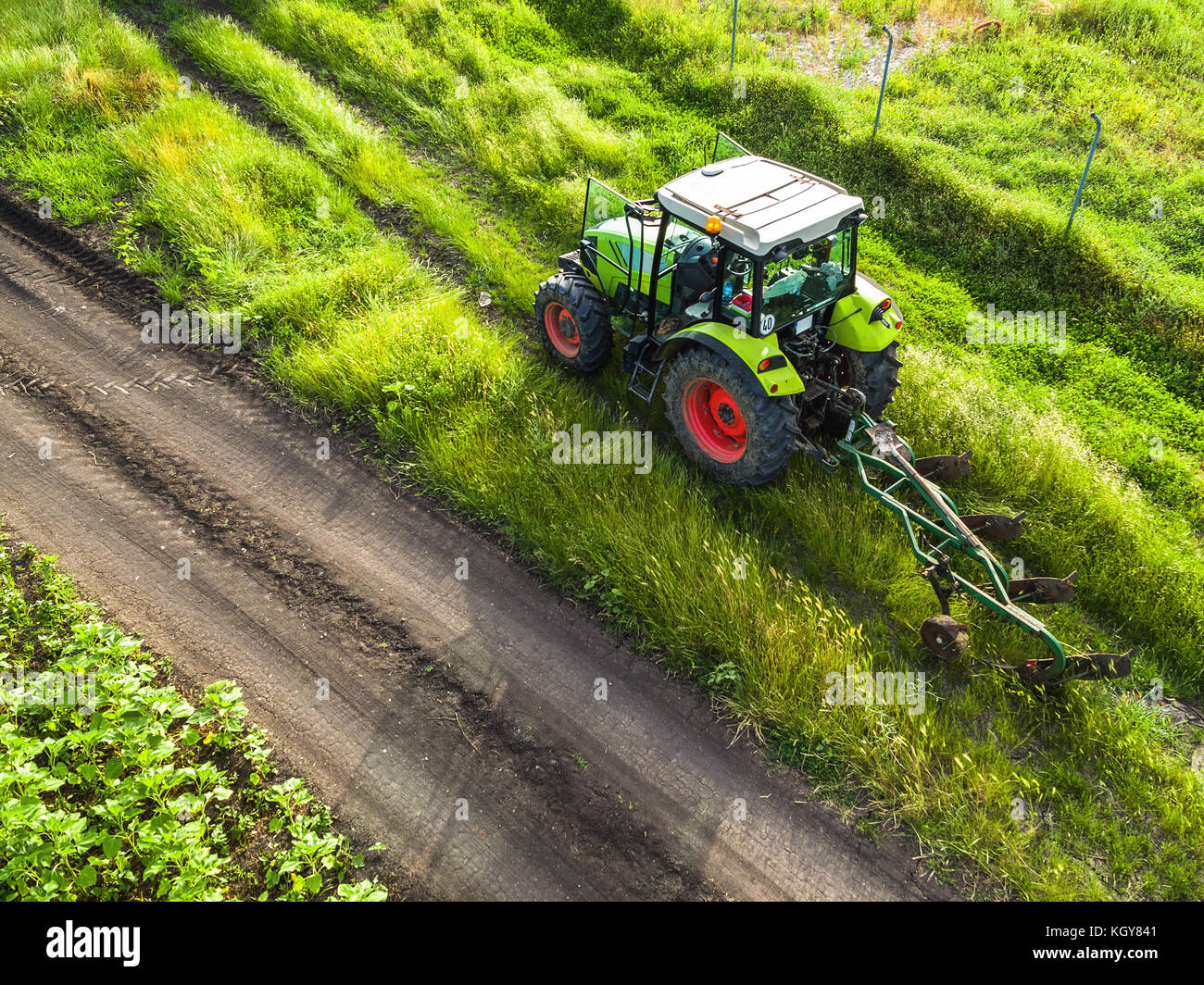Tractor cultivating field at spring,aerial view Stock Photo - Alamy