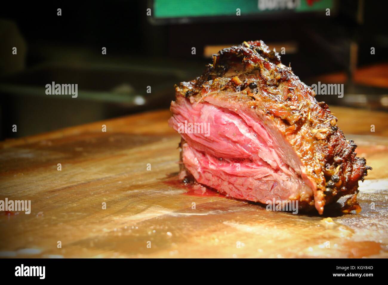 Sliced medium rare beef steak with pink flesh, roasted brown skin over ...
