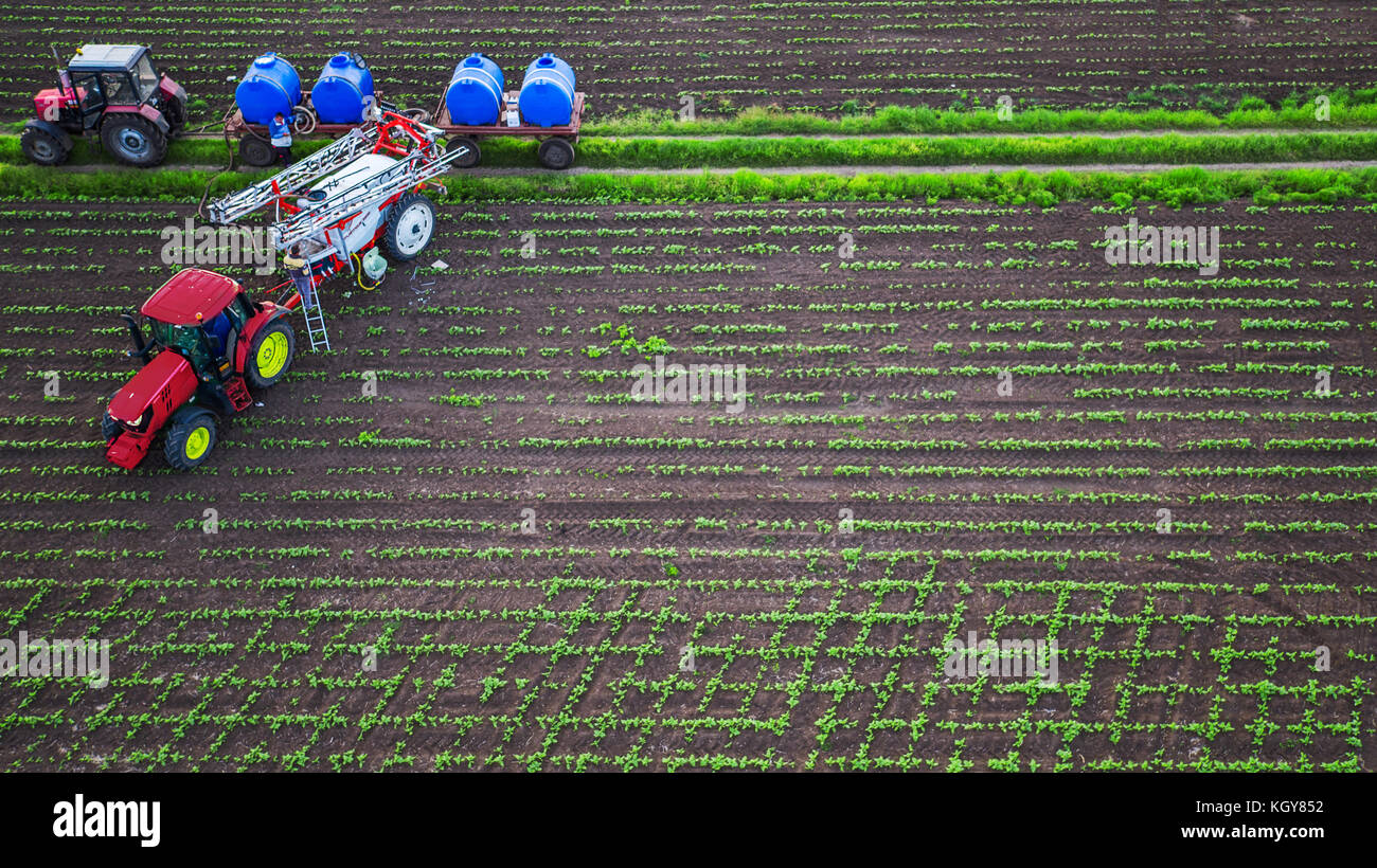Tractor spraying field at spring,aerial view Stock Photo - Alamy