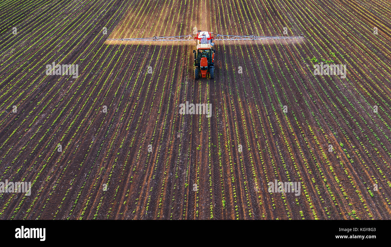 Tractor spraying field at spring,aerial view Stock Photo - Alamy