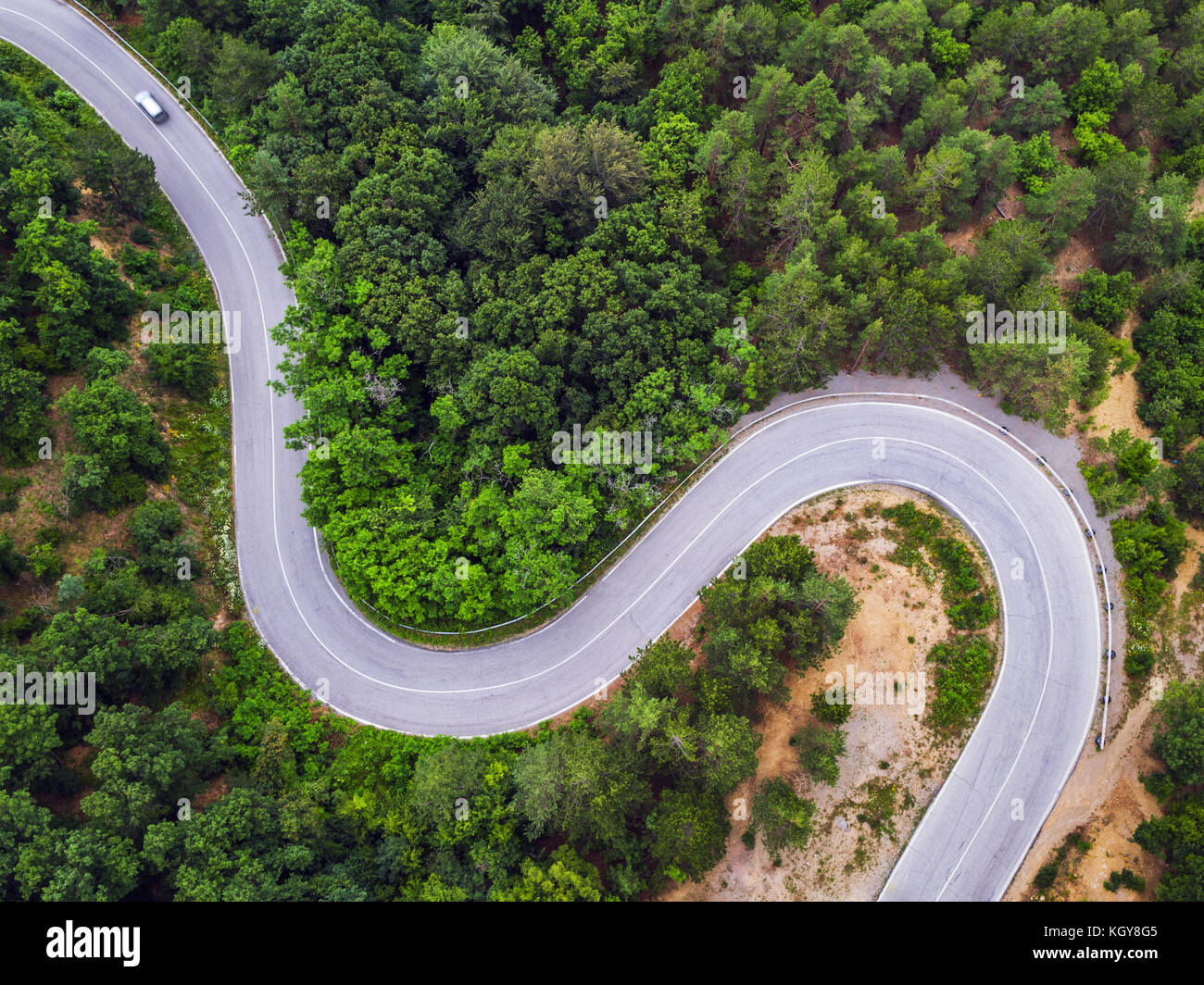 Aerial view over mountain road going through forest landscape Stock ...