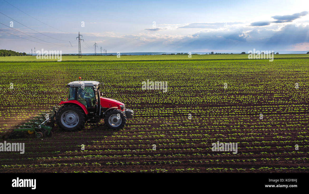 Tractor cultivating field at spring,aerial view Stock Photo - Alamy