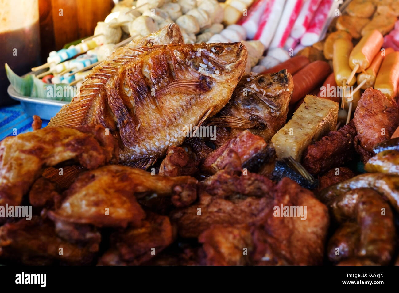 Fried fish on street asian market Stock Photo - Alamy