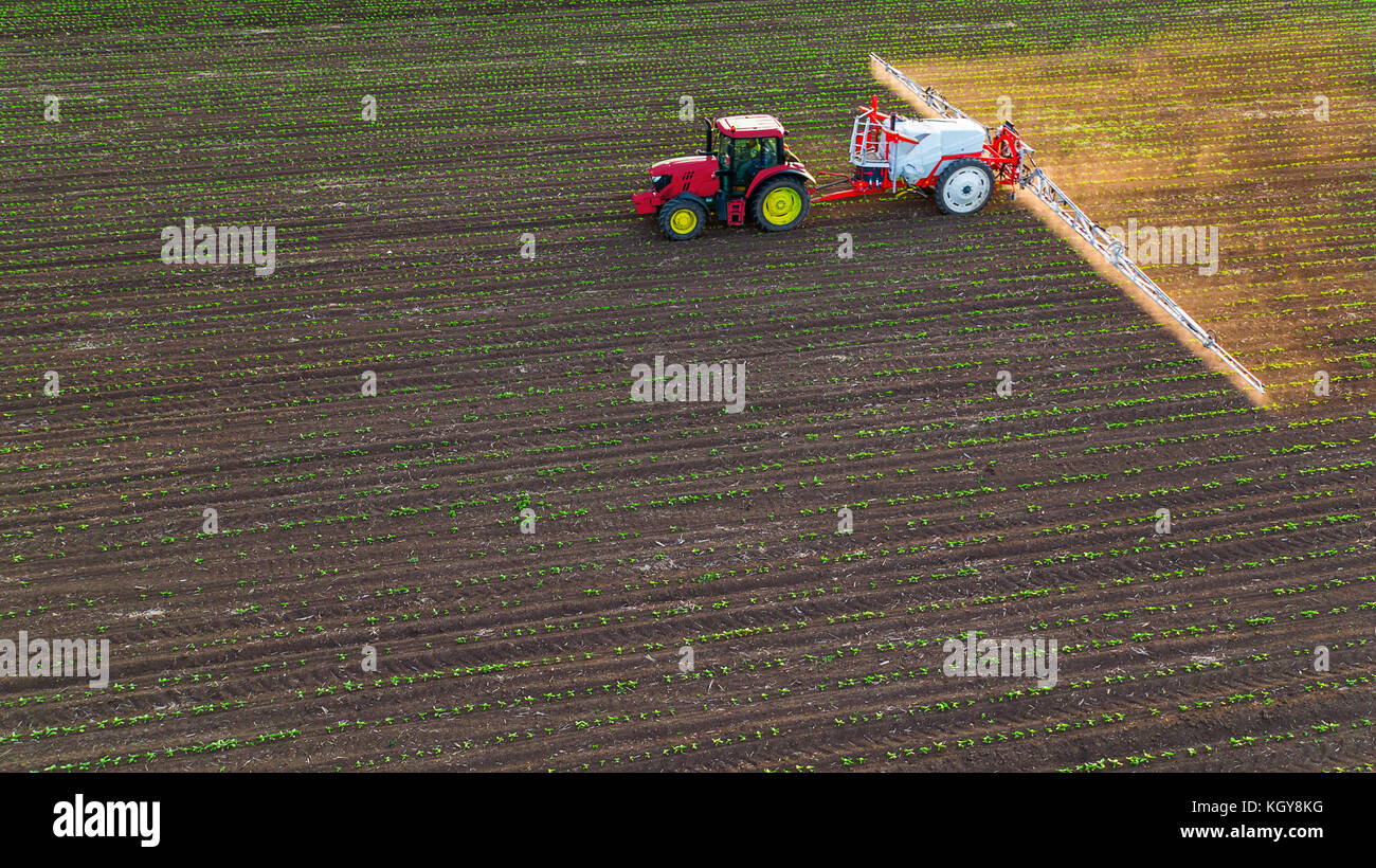 Tractor spraying field at spring,aerial view Stock Photo - Alamy