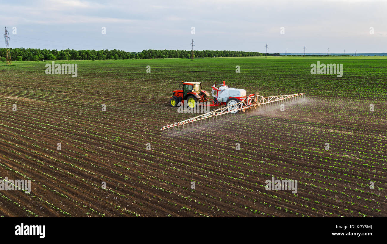 Tractor spraying field at spring,aerial view Stock Photo - Alamy