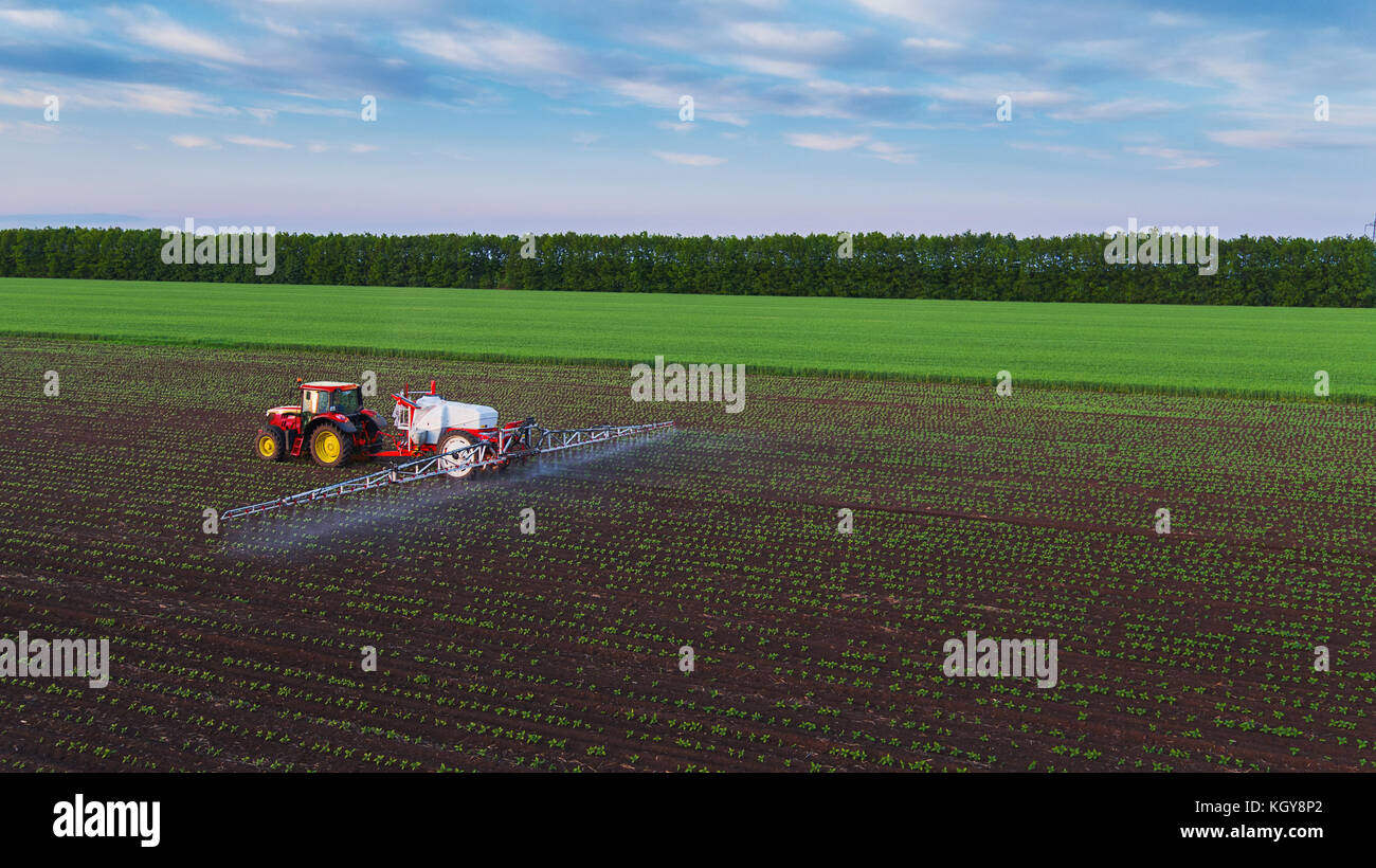 Tractor spraying field at spring,aerial view Stock Photo - Alamy