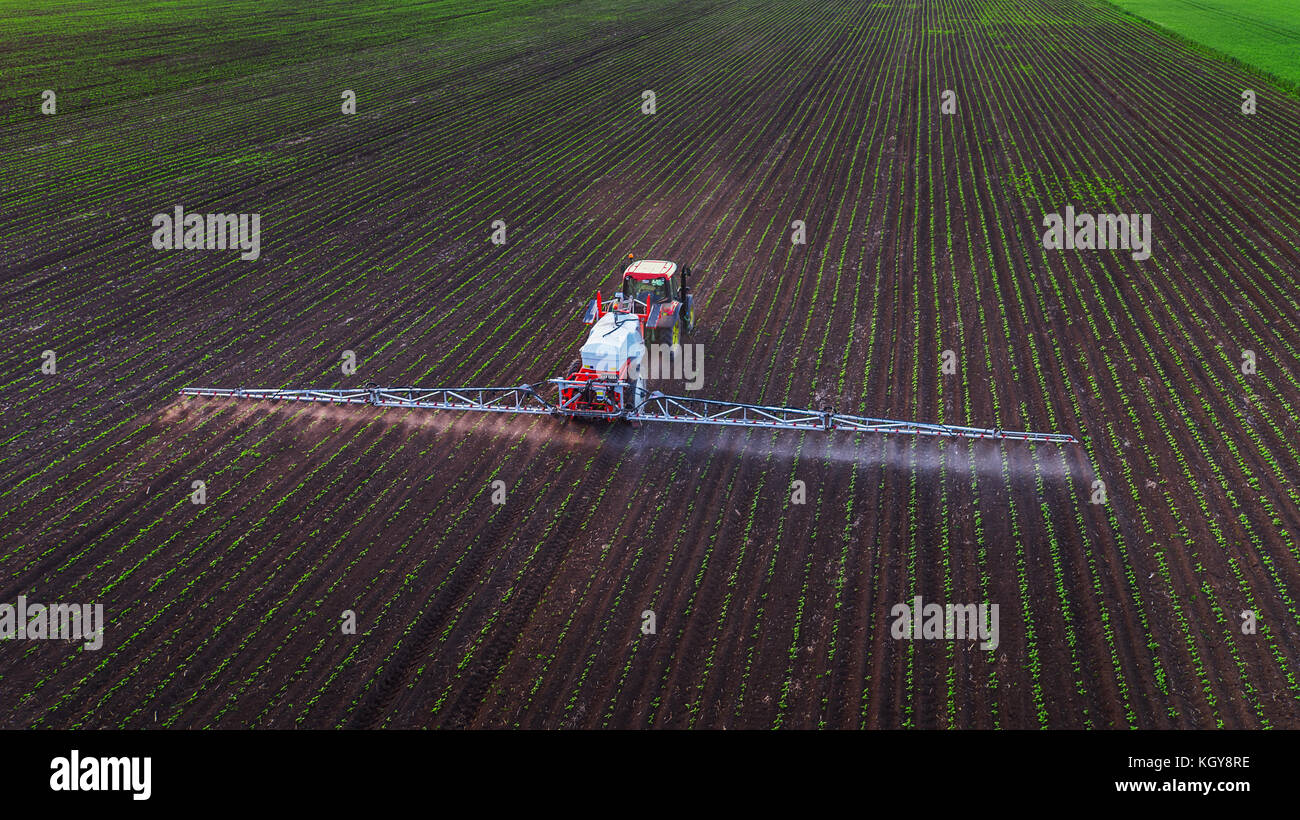 Tractor spraying field at spring,aerial view Stock Photo - Alamy