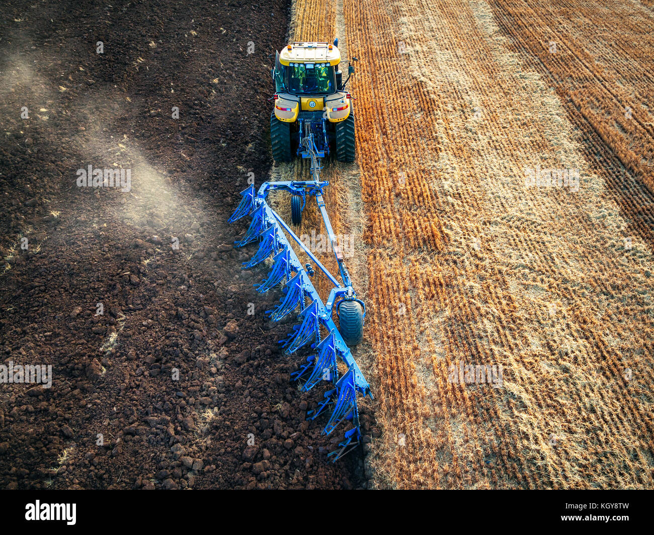 Tractor cultivating field at autumn,aerial view Stock Photo - Alamy