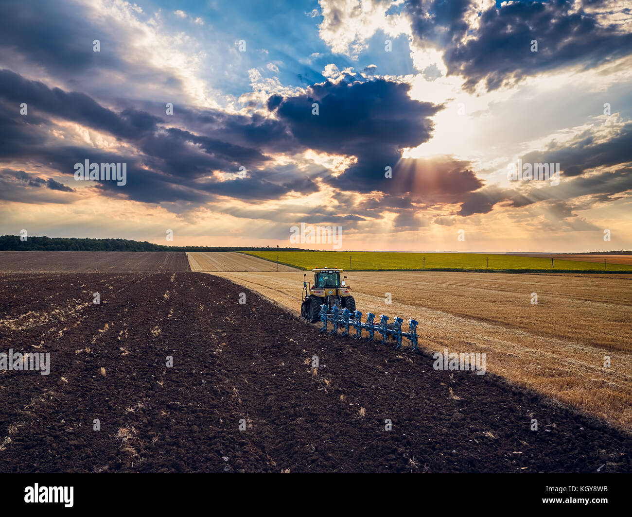 Tractor cultivating field at autumn,aerial view Stock Photo - Alamy
