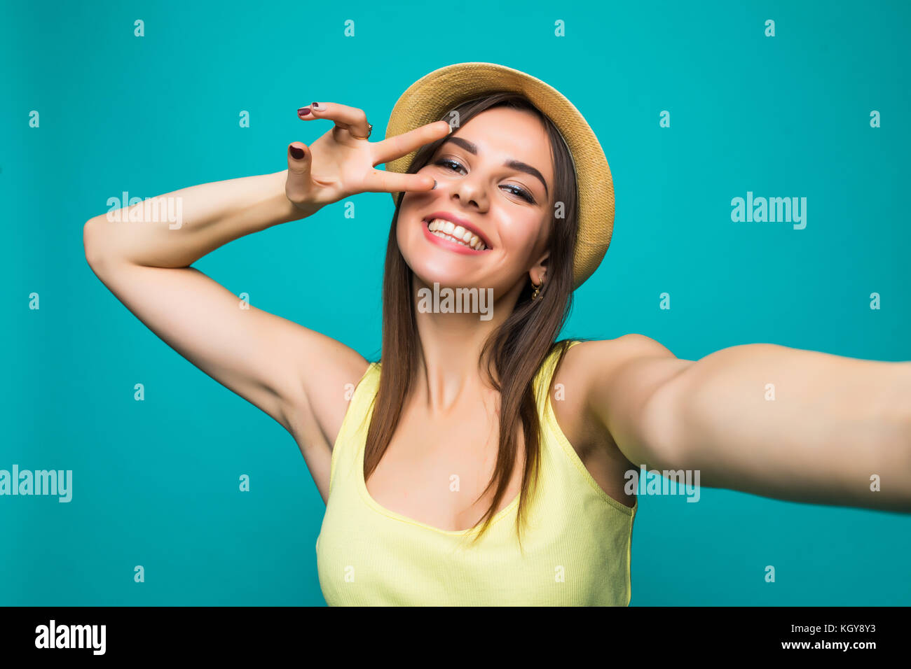 Young pretty taking a selfie on a color background Stock Photo - Alamy