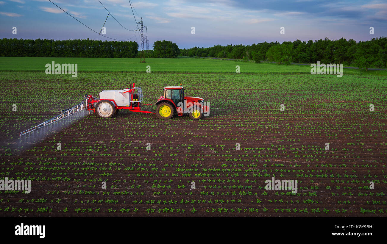 Tractor spraying field at spring,aerial view Stock Photo - Alamy