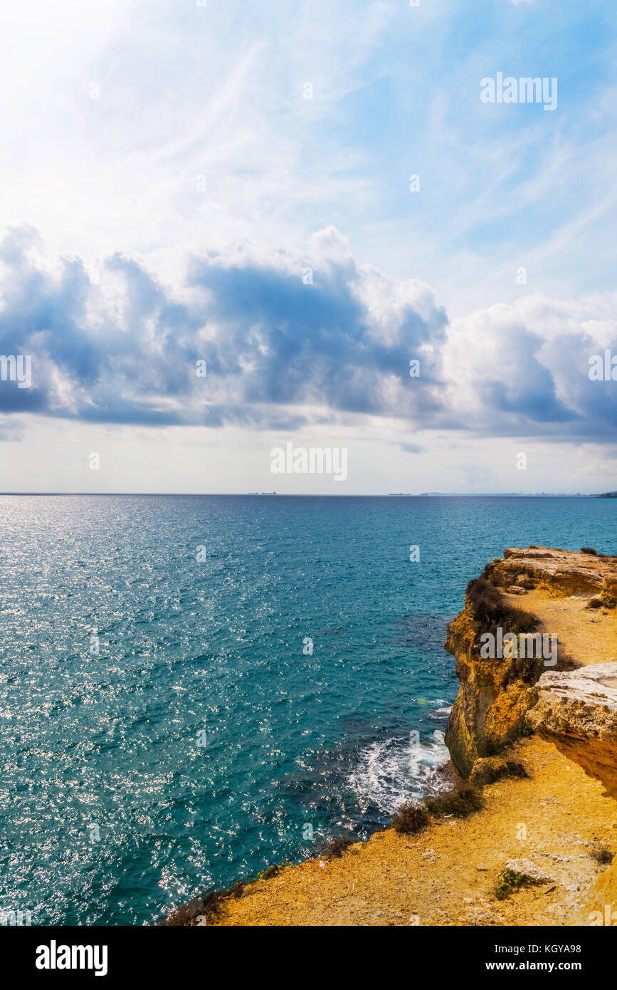 high cliff above the sea, summer sea background, many splashing waves ...