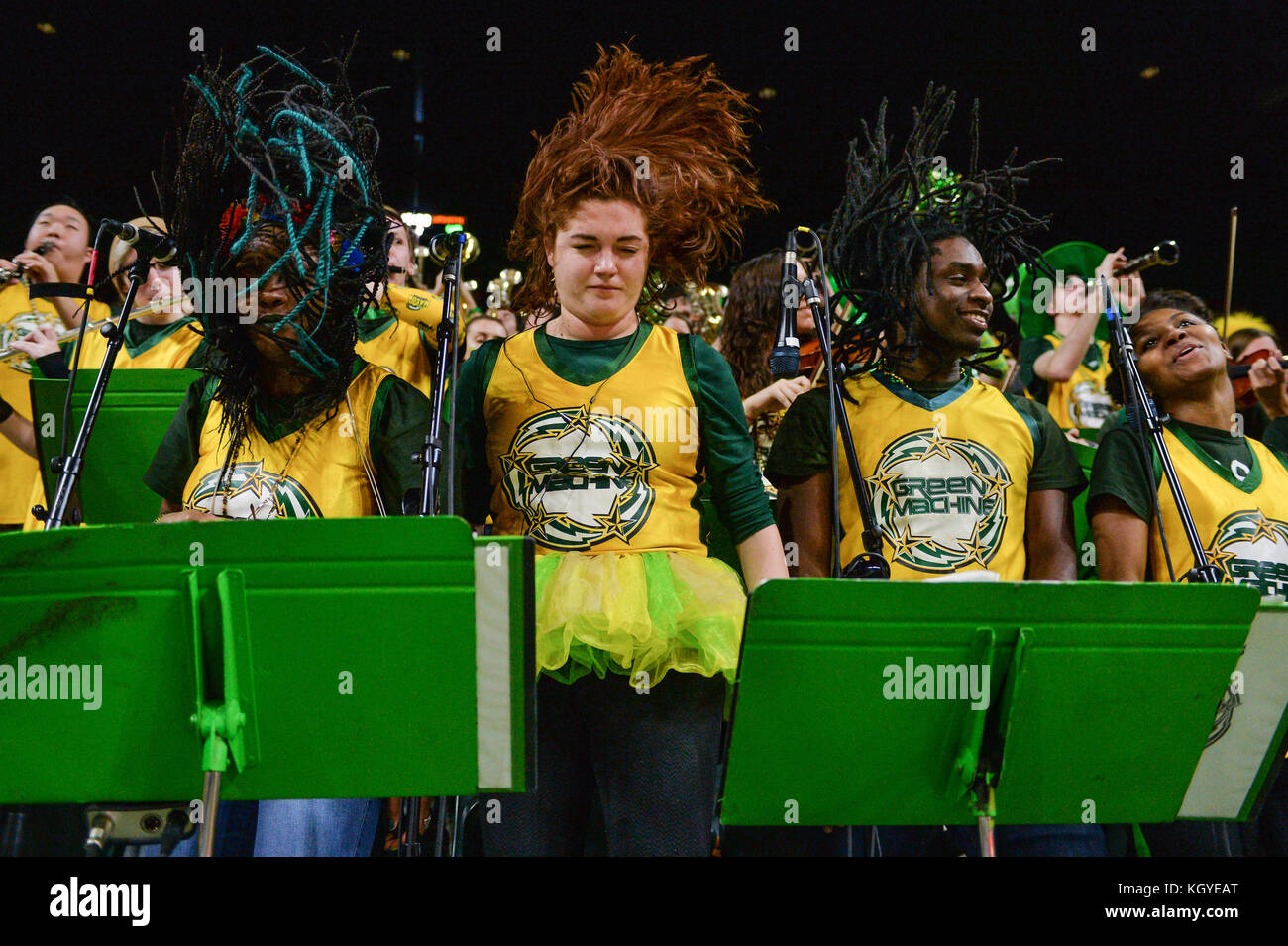 Members of the Green Machine band dance during the game held at ...