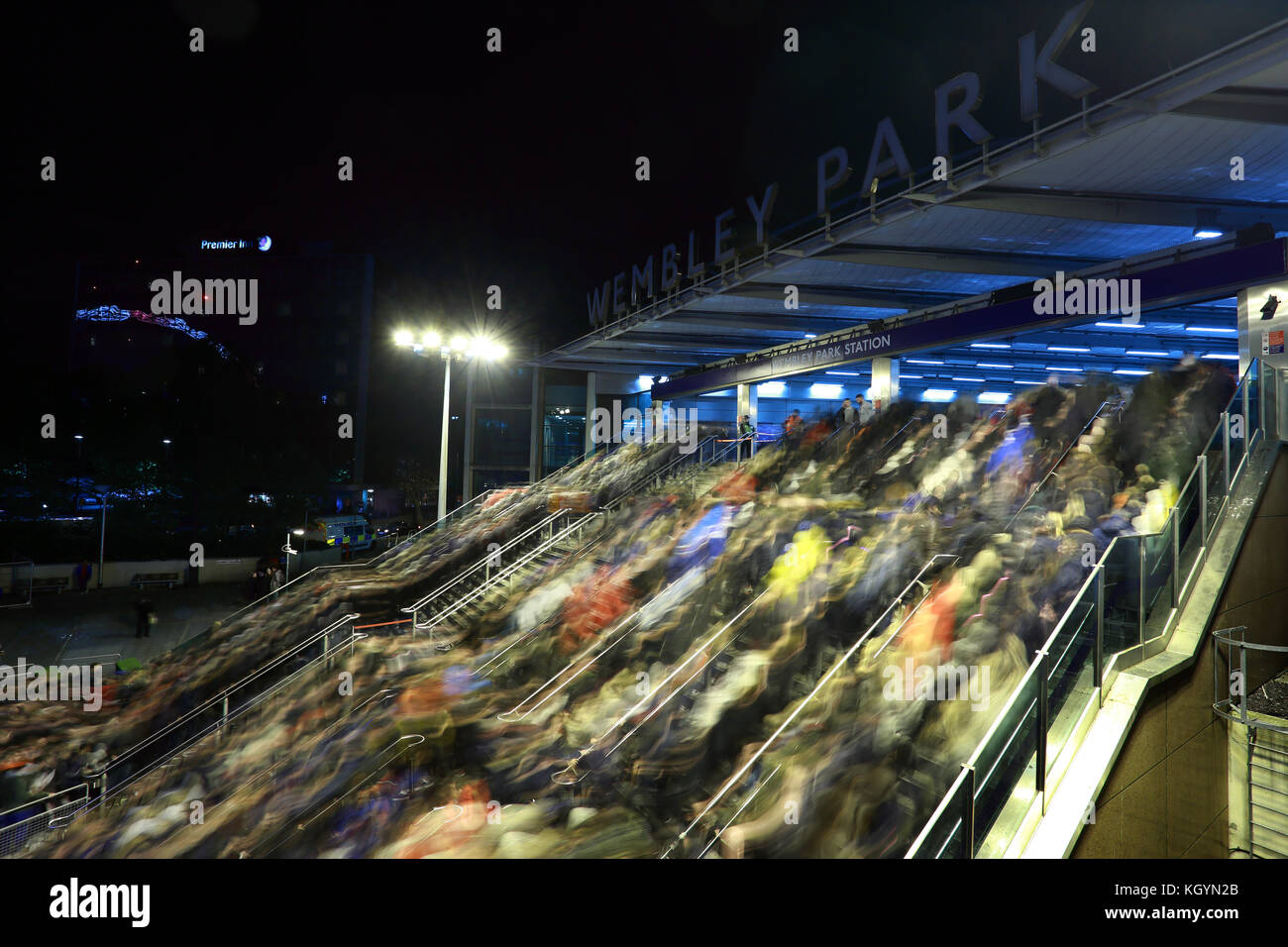 Football fans are blurred as they leave Wembley Stadium and enter ...