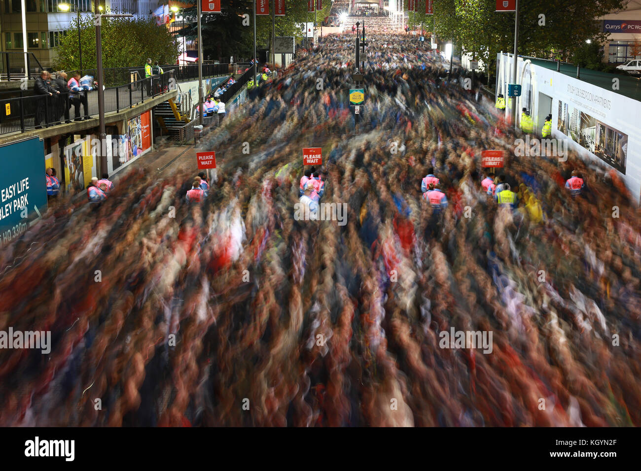 Football fans are blurred as they leave Wembley Stadium after the ...