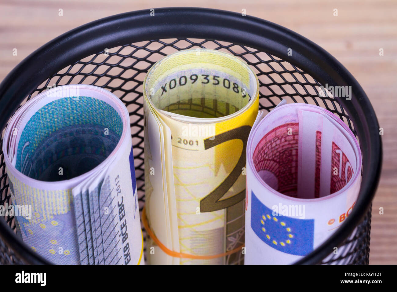 Bankroll cash euro banknotes in garbage basket focused on consuming in ...