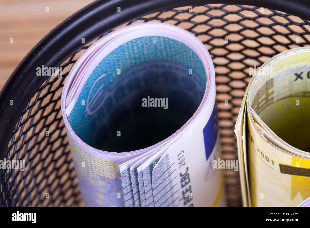 Bankroll cash euro banknotes in garbage basket focused on consuming in ...