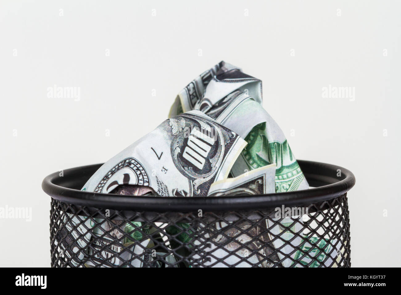 Dollar banknotes crumpled inside garbage basket, rubbish bin focused on ...