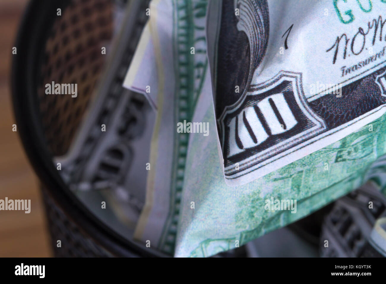 Dollar banknotes crumpled inside garbage basket, rubbish bin focused on ...