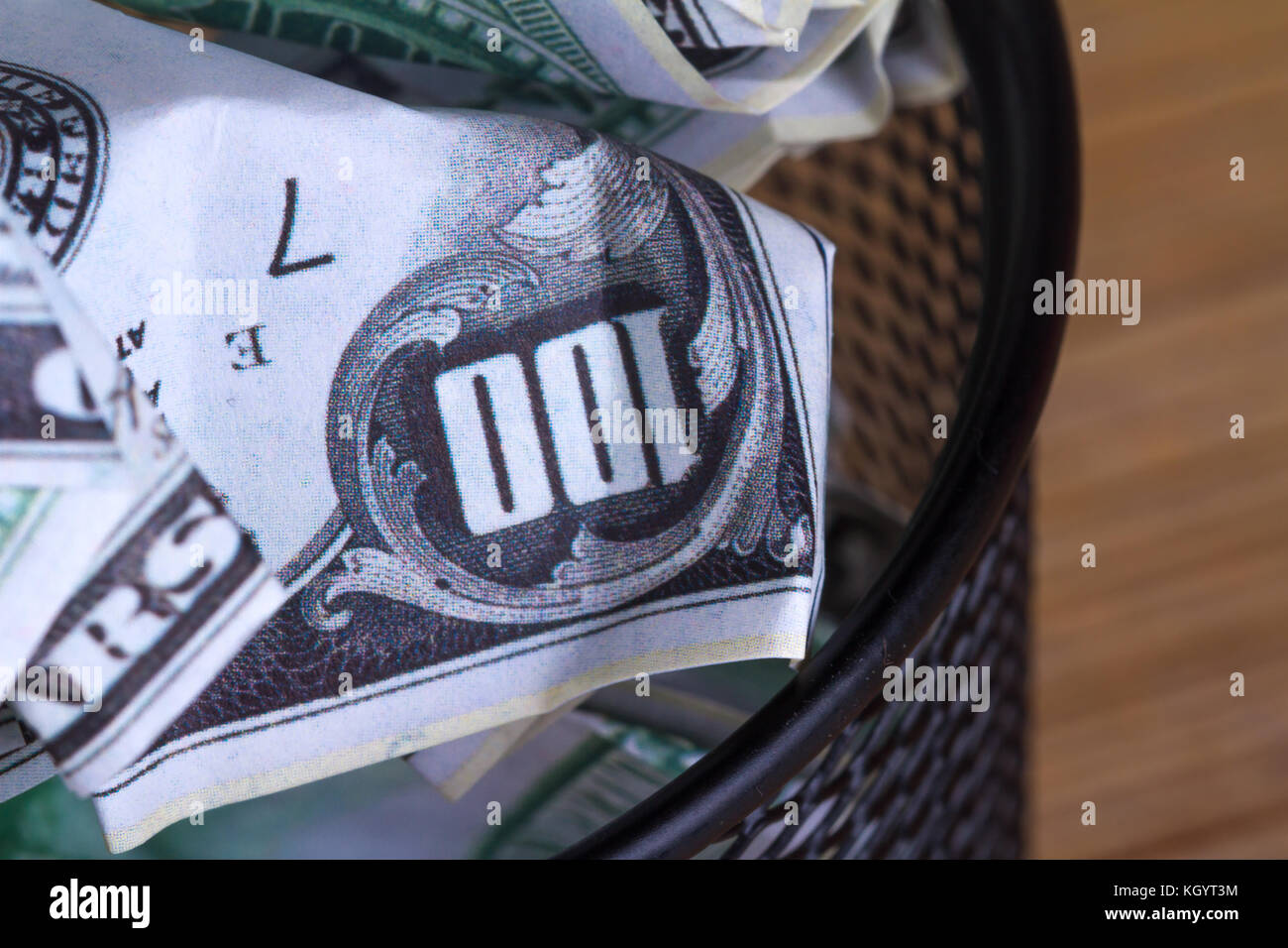 Dollar banknotes crumpled inside garbage basket, rubbish bin focused on ...