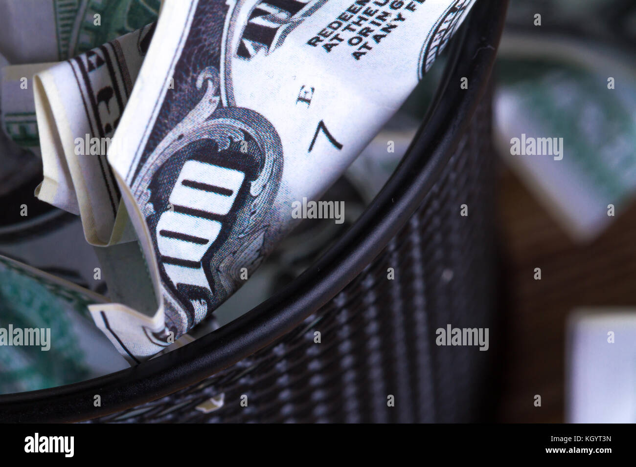 Dollar banknotes crumpled inside garbage basket, rubbish bin focused on ...