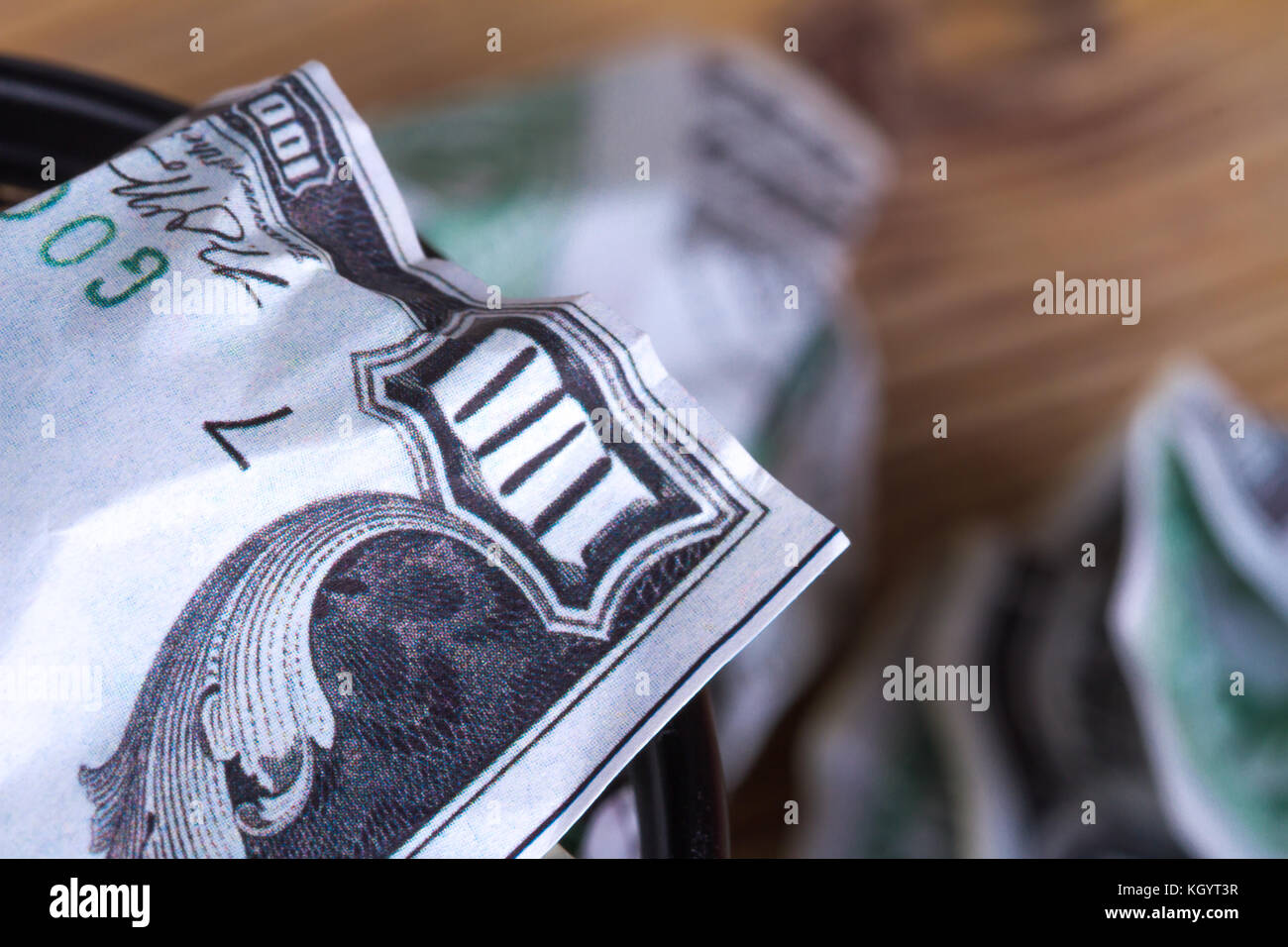 Dollar banknotes crumpled inside garbage basket, rubbish bin focused on ...