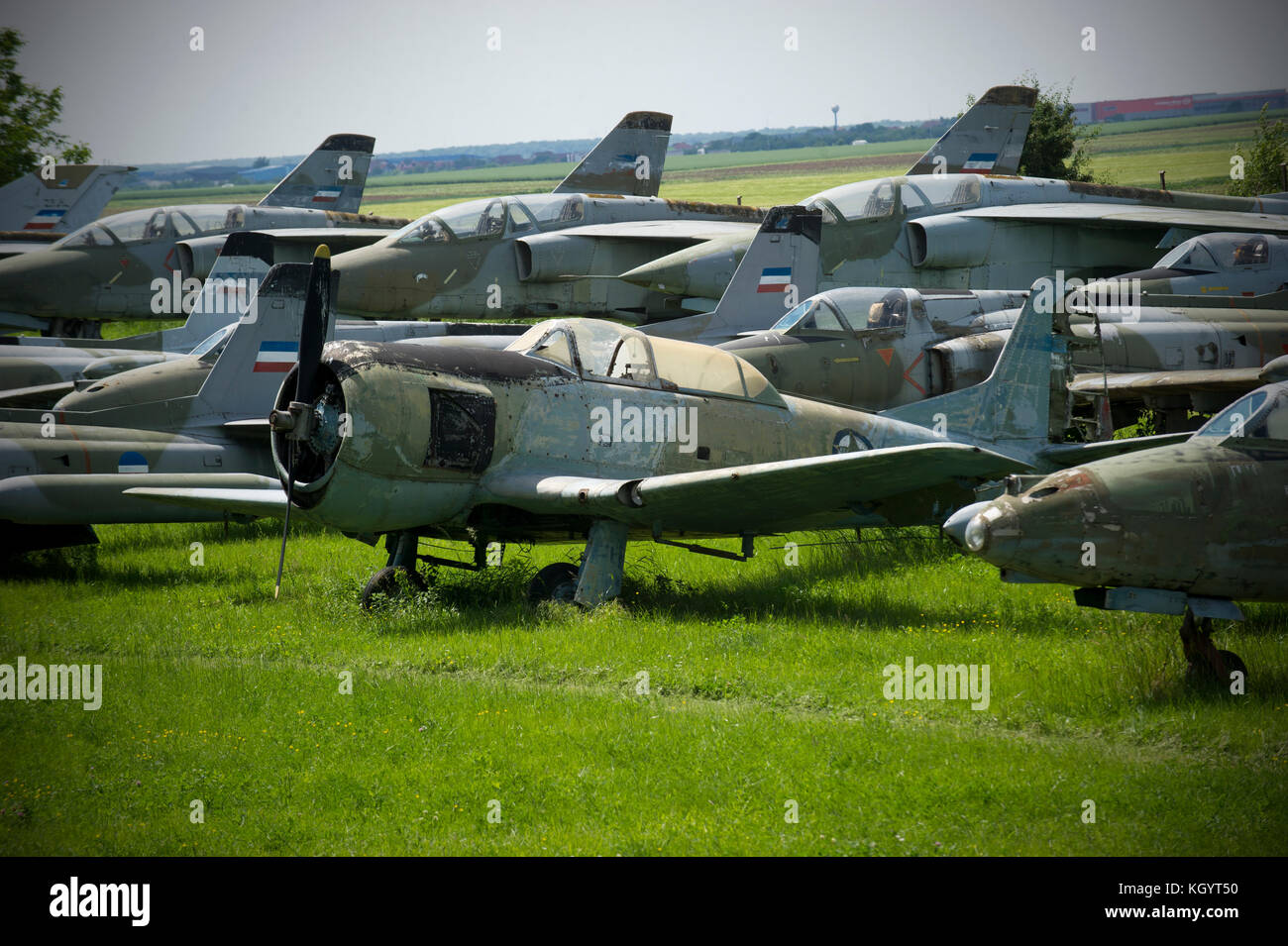 Old military fighter jets in the field Stock Photo - Alamy
