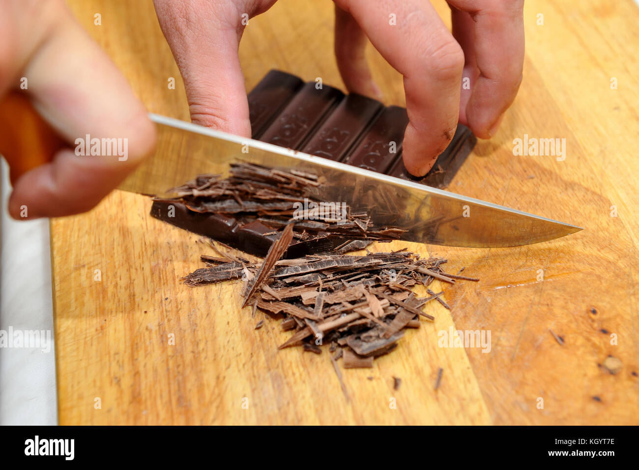 Chopping bar chocolate for making tasty cake Stock Photo - Alamy