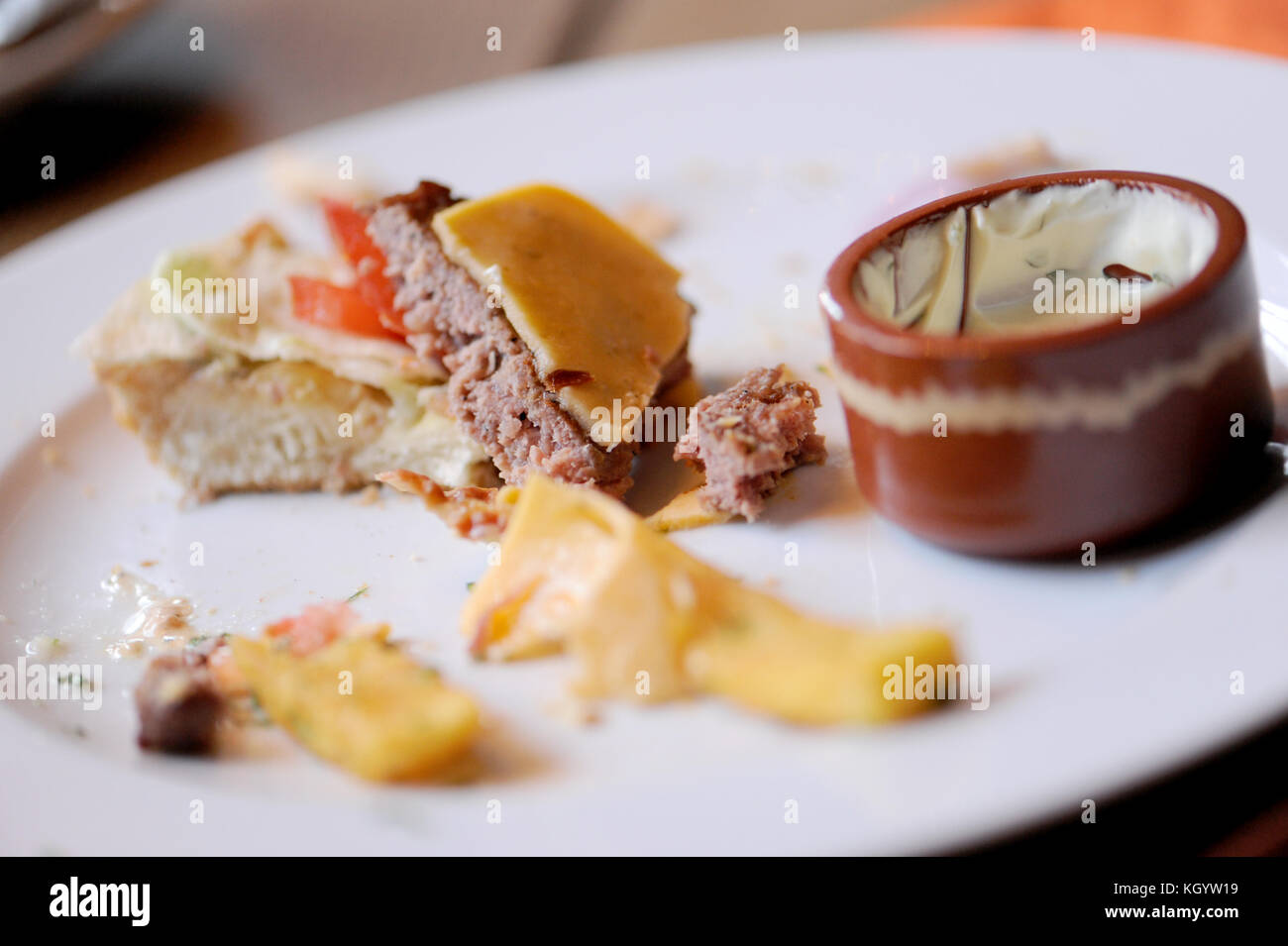 Messy food leftovers. Burger leftover on the plate after party Stock ...