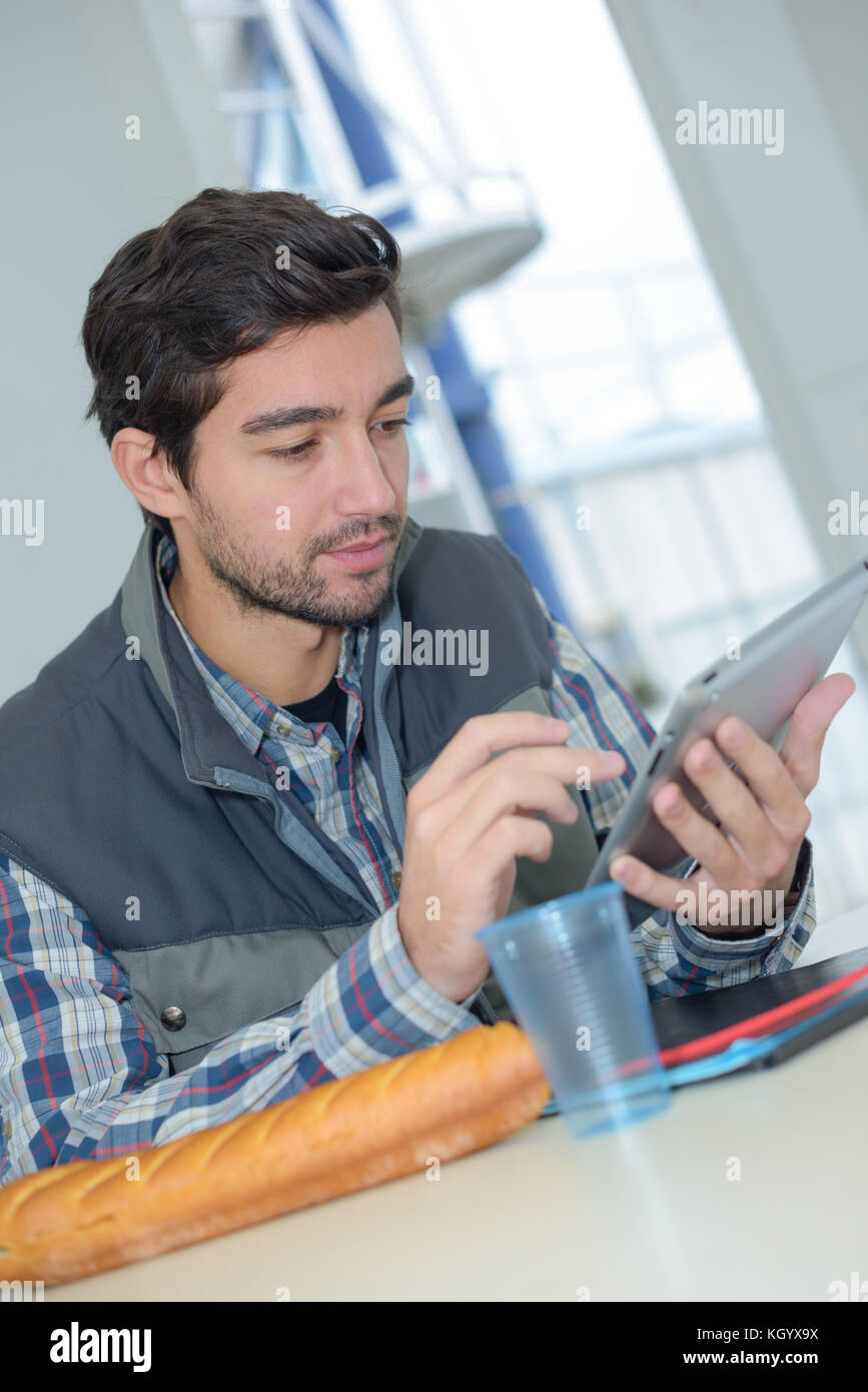 Man on break using tablet Stock Photo - Alamy