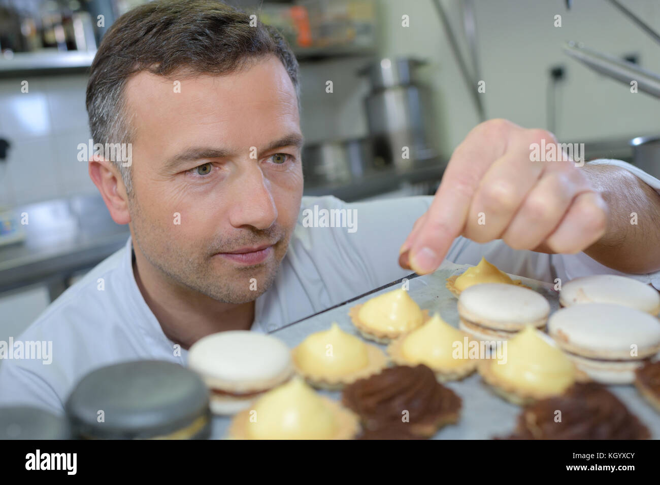Male confectioner decorating tasty hi-res stock photography and images ...