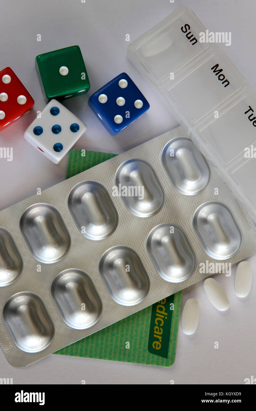 Medicinal pills with dice suggesting pill taking is a gamble Stock ...
