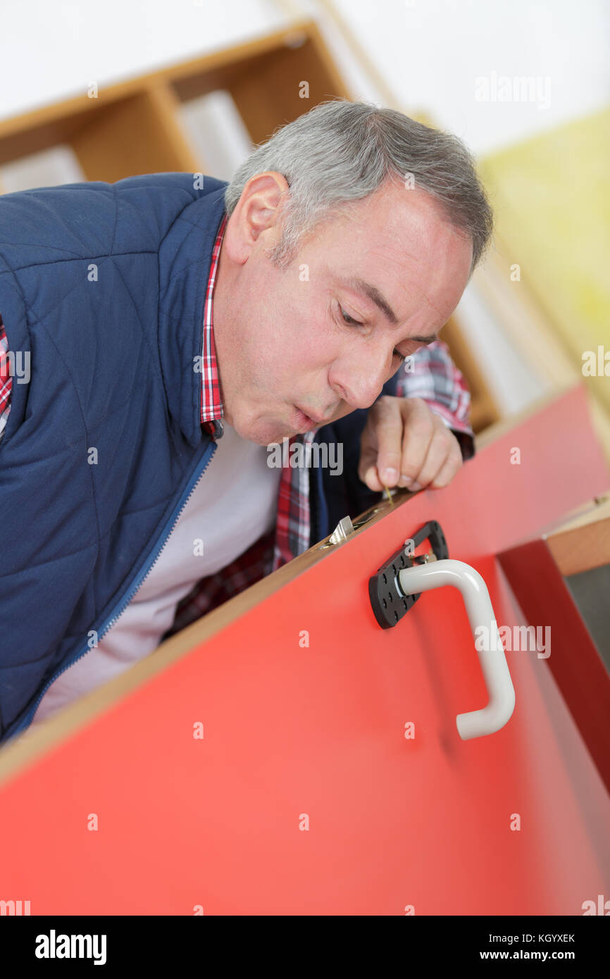 man fixing the door with screwdriver Stock Photo - Alamy