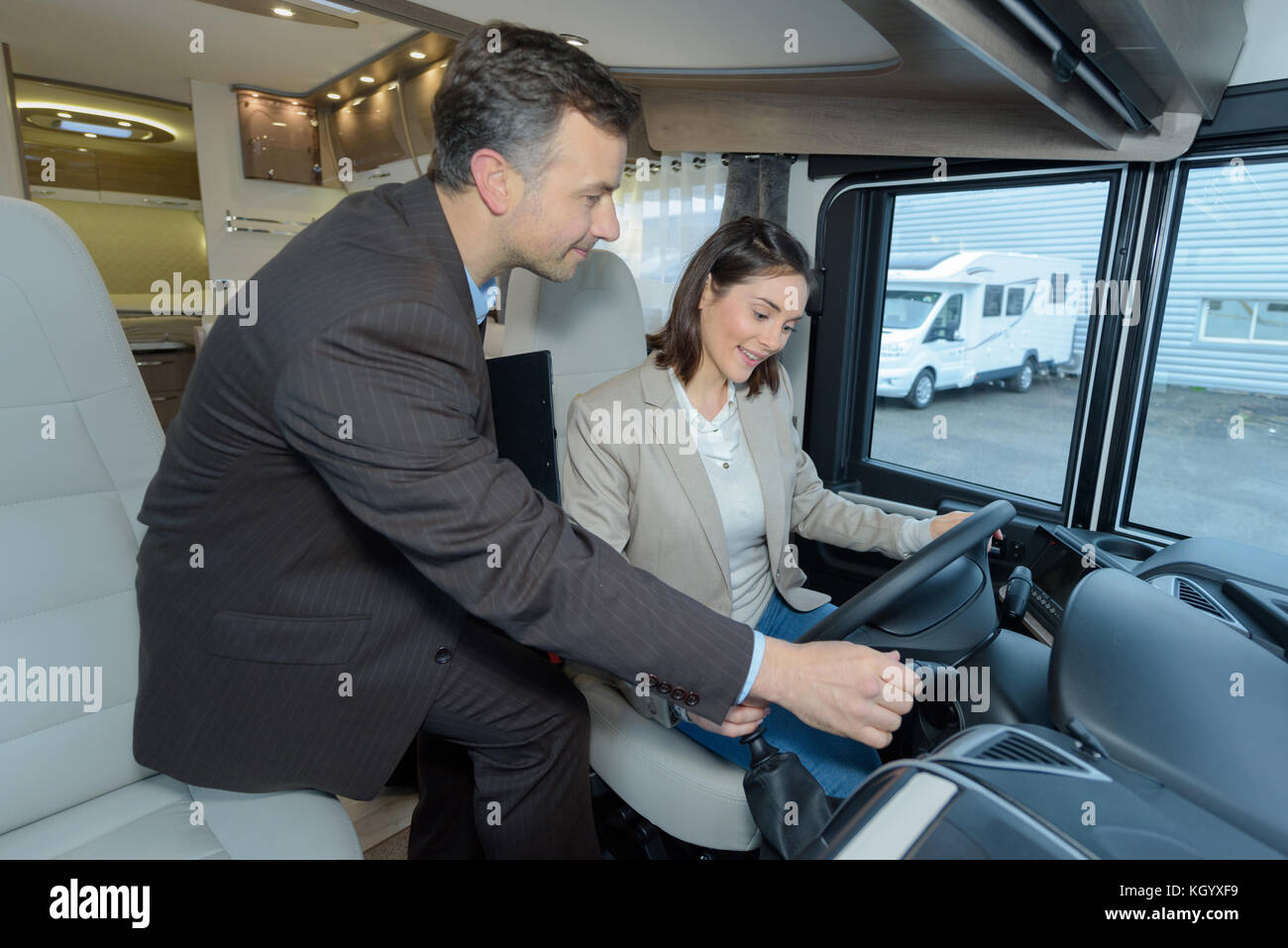 modern woman in caravan with a salesman Stock Photo - Alamy