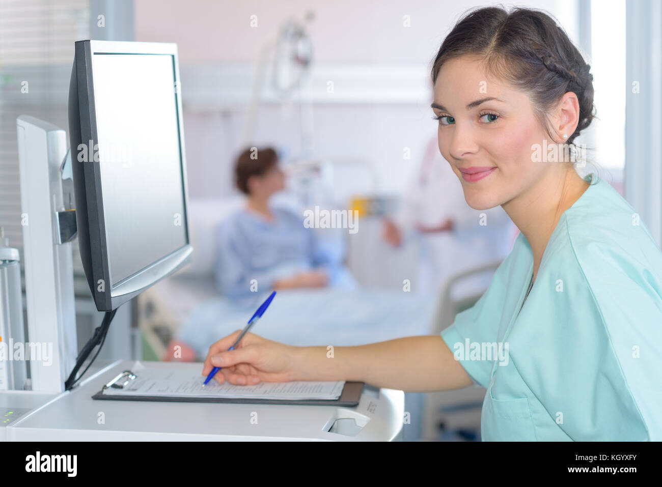Nurse with clipboard at computer Stock Photo - Alamy