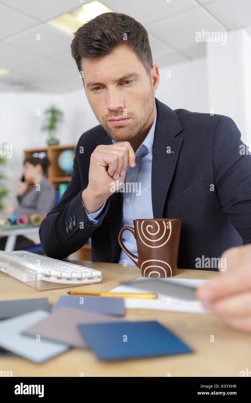 office worker having difficult time to choose the shade Stock Photo - Alamy