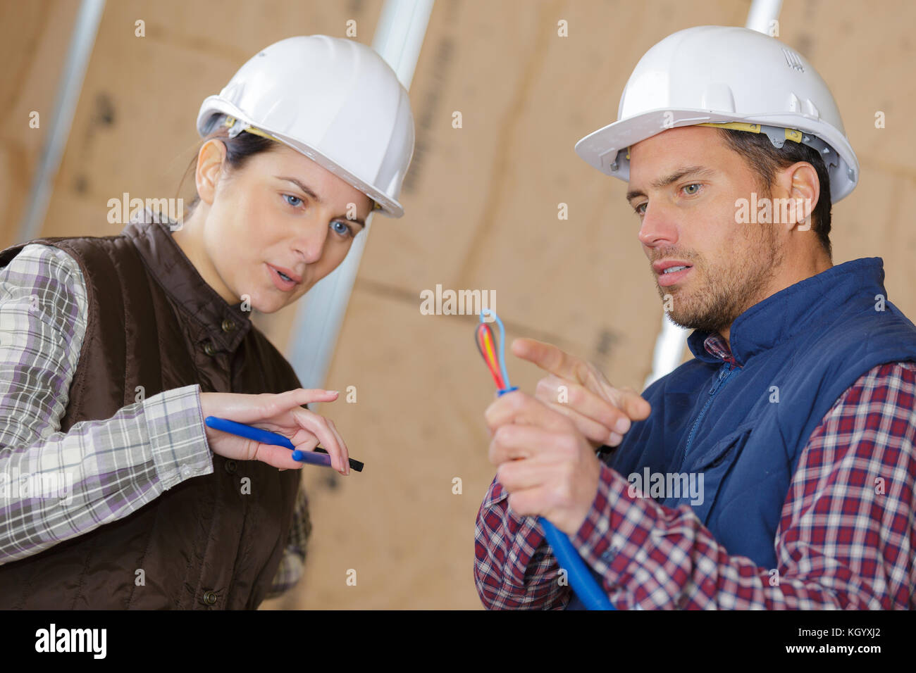 professional electrician workers with safety protective equipment to ...