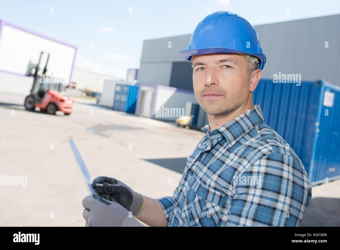 Man in factory yard Stock Photo - Alamy
