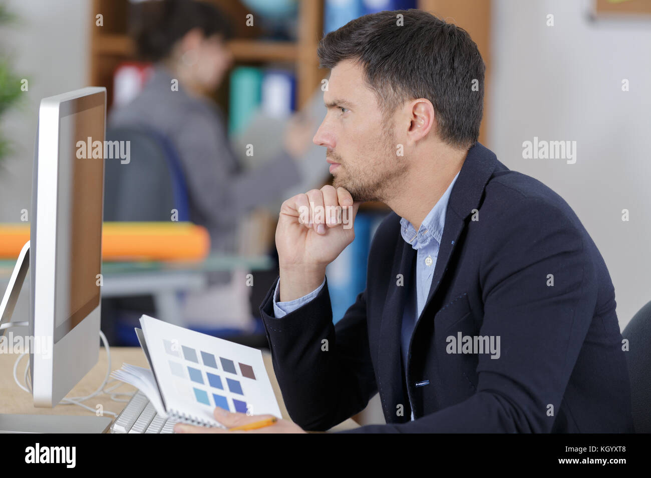 man doing some design work in a desktop computer Stock Photo - Alamy
