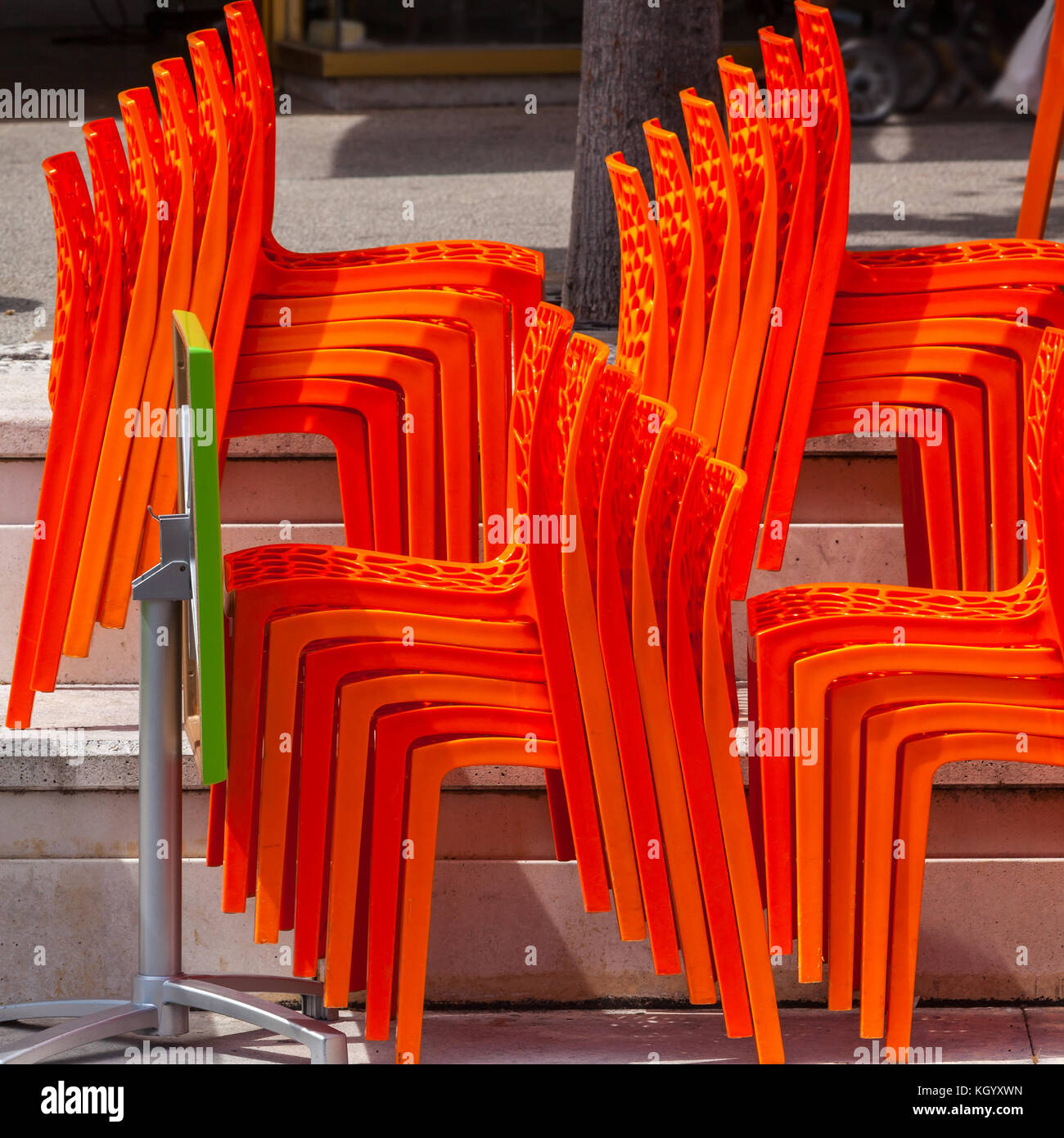 Piles of plastic chairs in a closed cafe. Square shot Stock Photo - Alamy