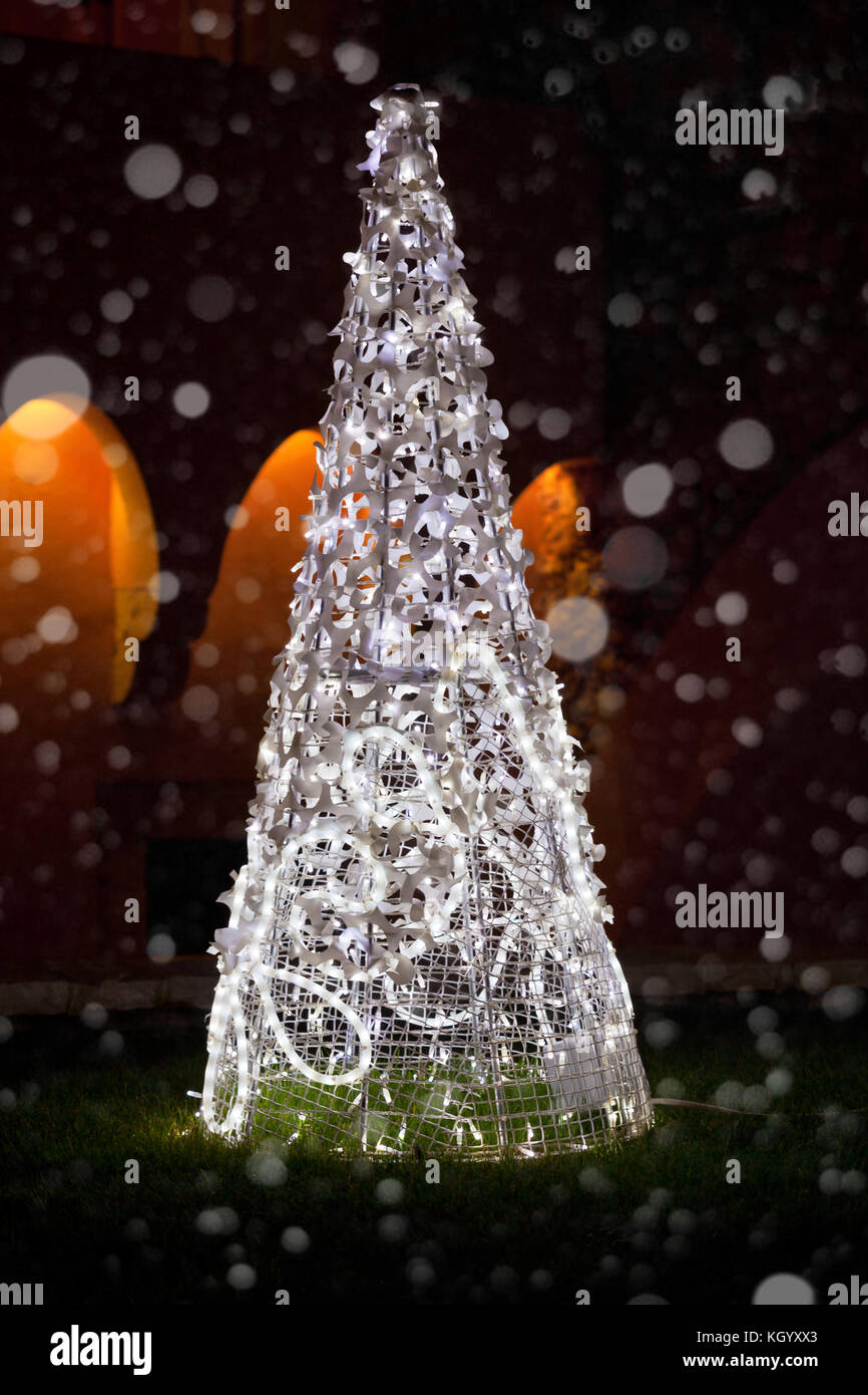 Outdoor Pine christmas tree figure with white lights Stock Photo - Alamy