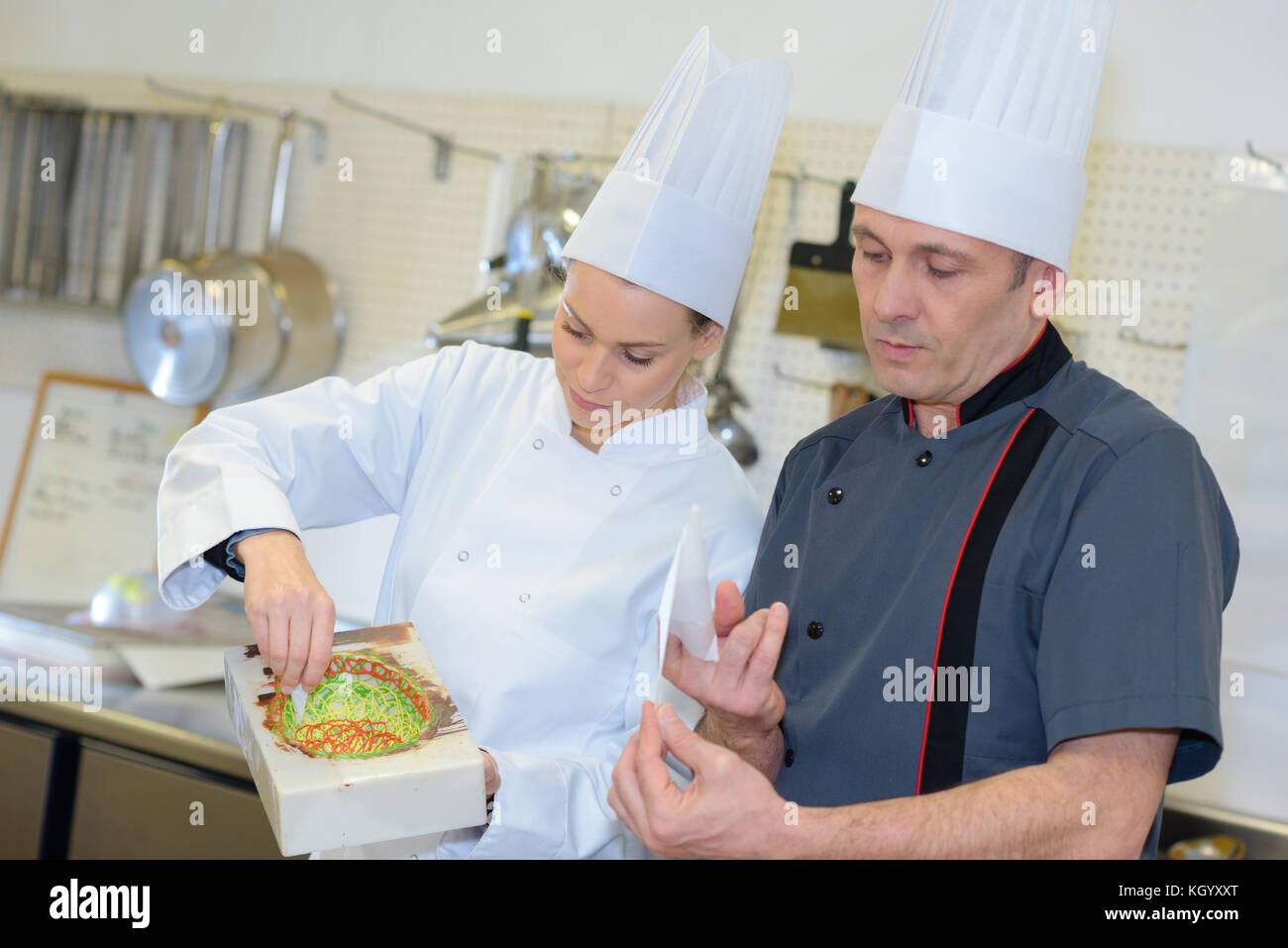male and female chefs working at kitchen Stock Photo - Alamy