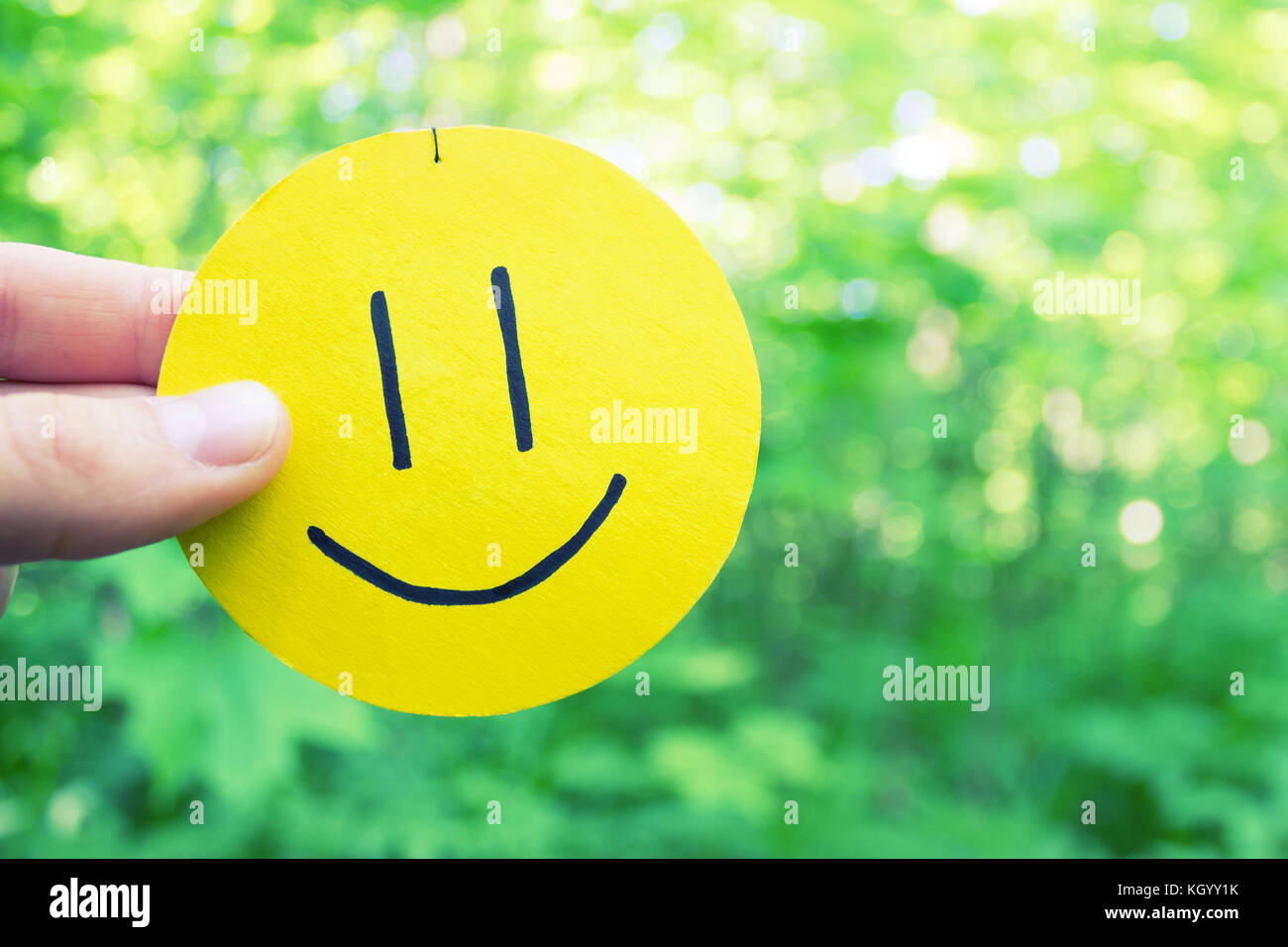 yellow smile on green leaves background. love to nature. positive ...