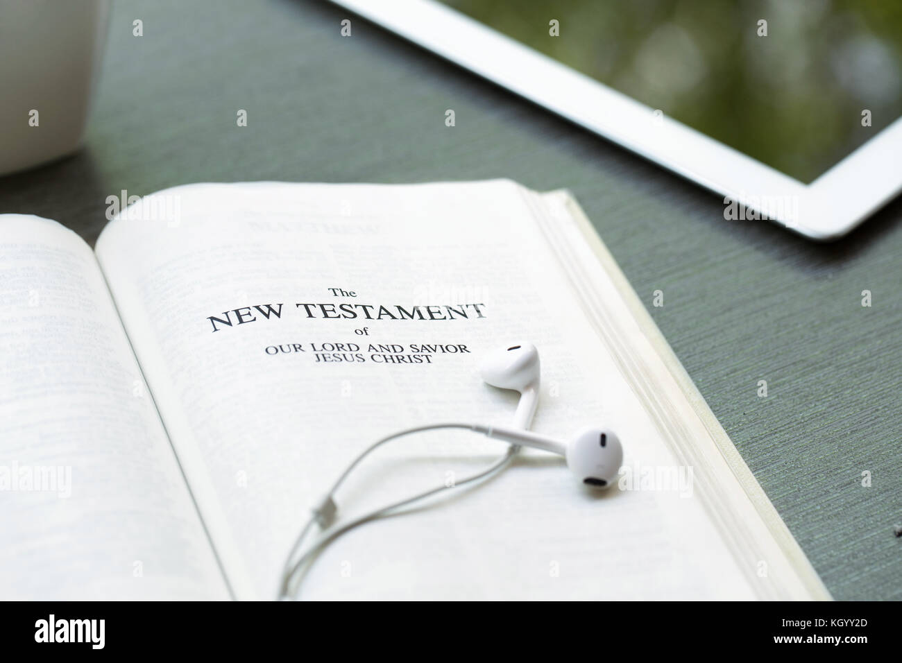 Christian background of a Bible ipad and earbuds Stock Photo - Alamy