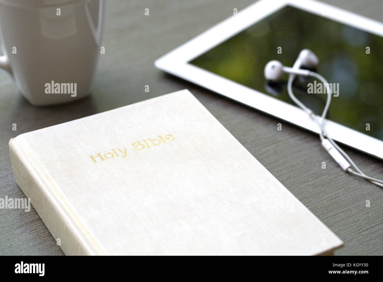 Christian background of a Bible ipad and earbuds Stock Photo - Alamy