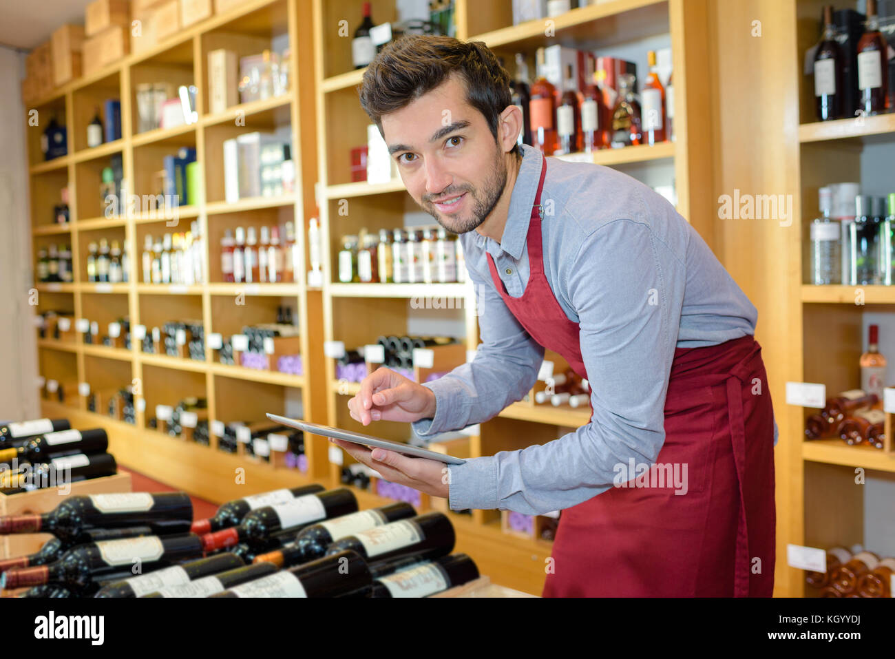 young man working in wine shop Stock Photo - Alamy