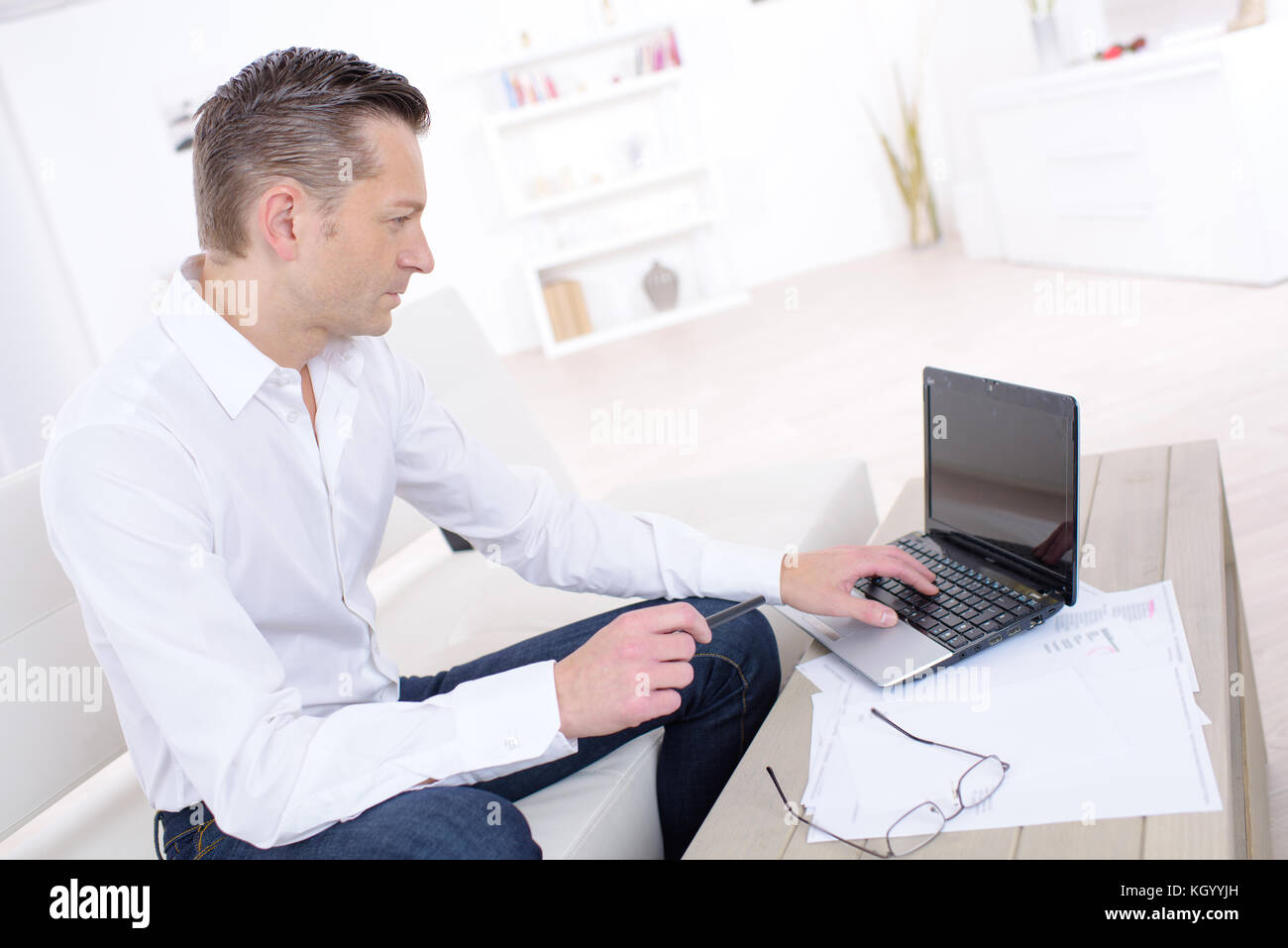 man using a laptop at home Stock Photo - Alamy