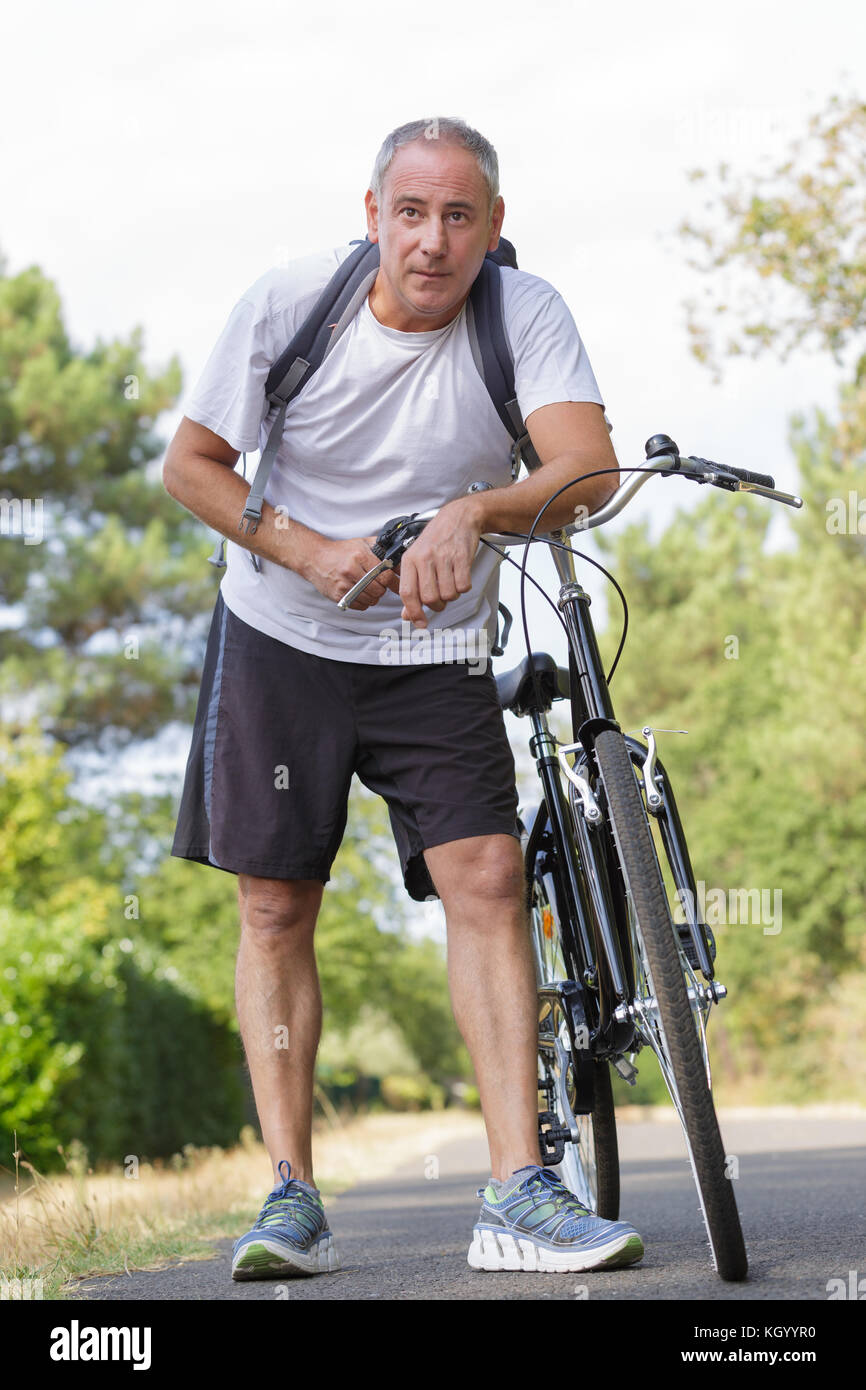senior cyclist enjoying nature and making a pause Stock Photo - Alamy