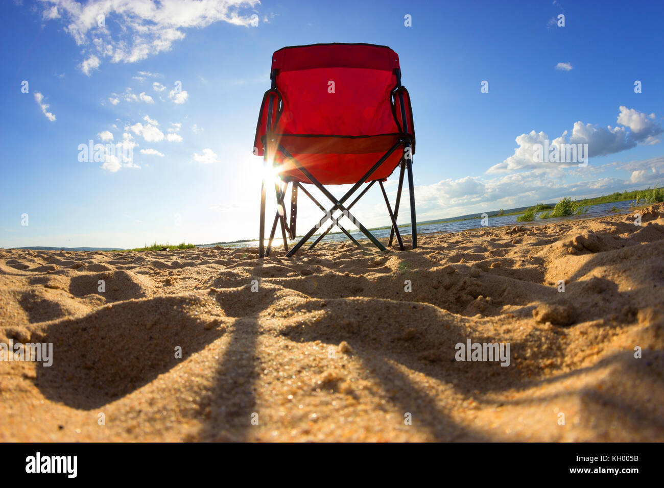 red beach chair on the beach. sunny day Stock Photo - Alamy